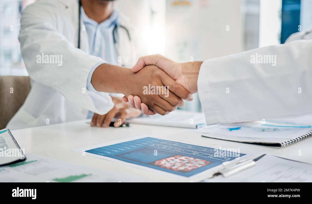 Closeup handshake, doctors and agreement for documents, research or ...