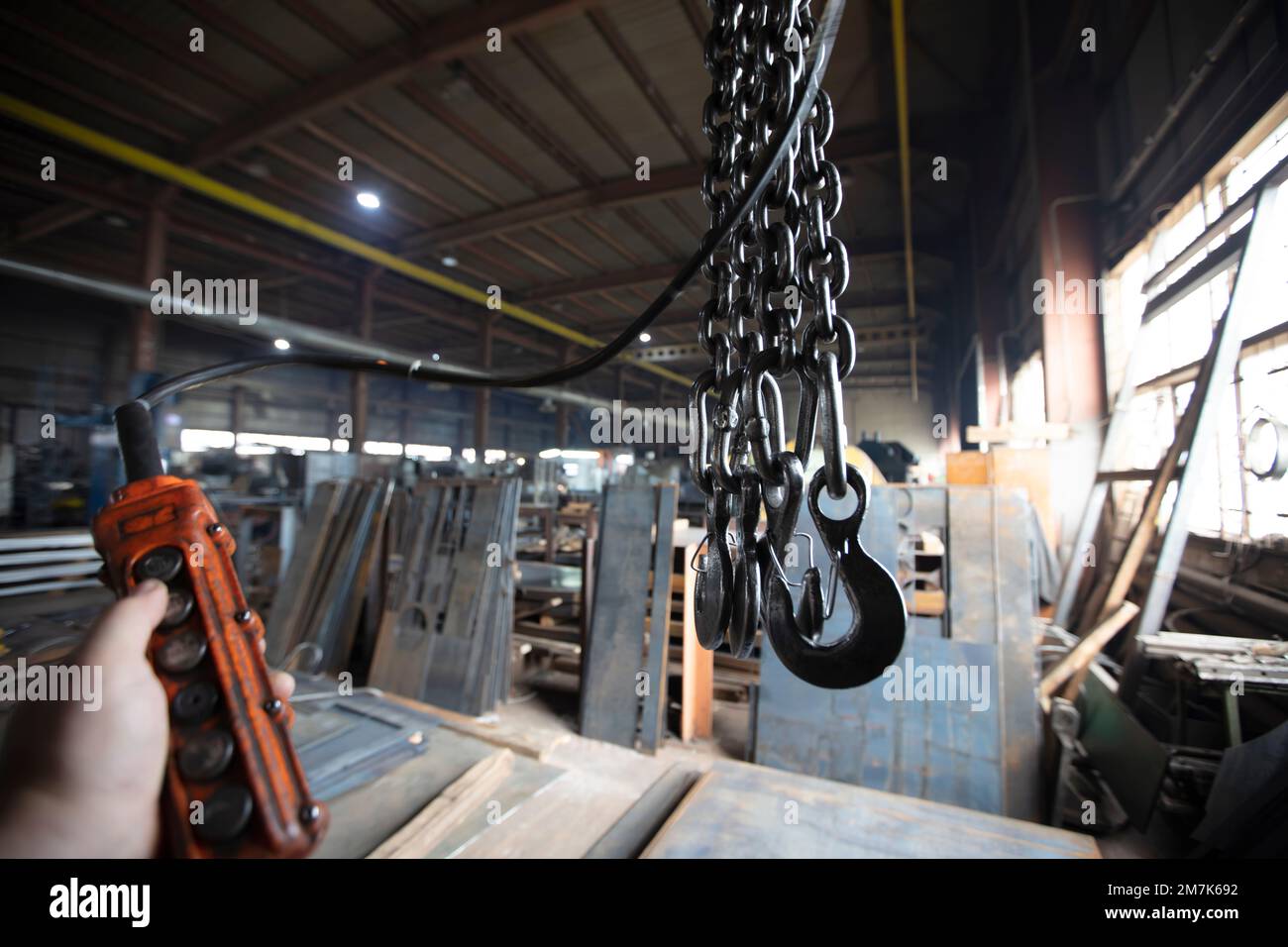 Metal industrial chains with hooks in the workshop of a metallurgical ...