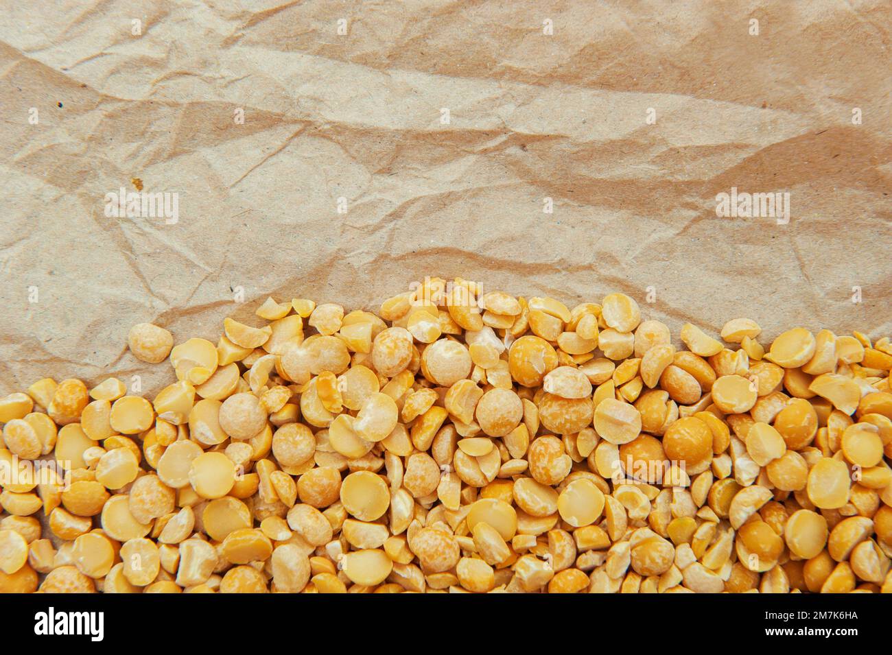 Abstract background with grains of peas on crumpled old parchment ...