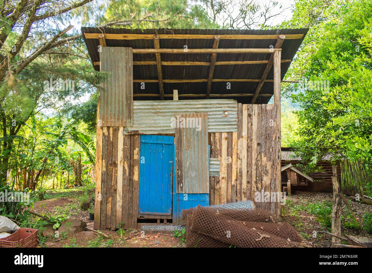Rustic shed made of wood and rusted iron roof sheets in the countryside ...