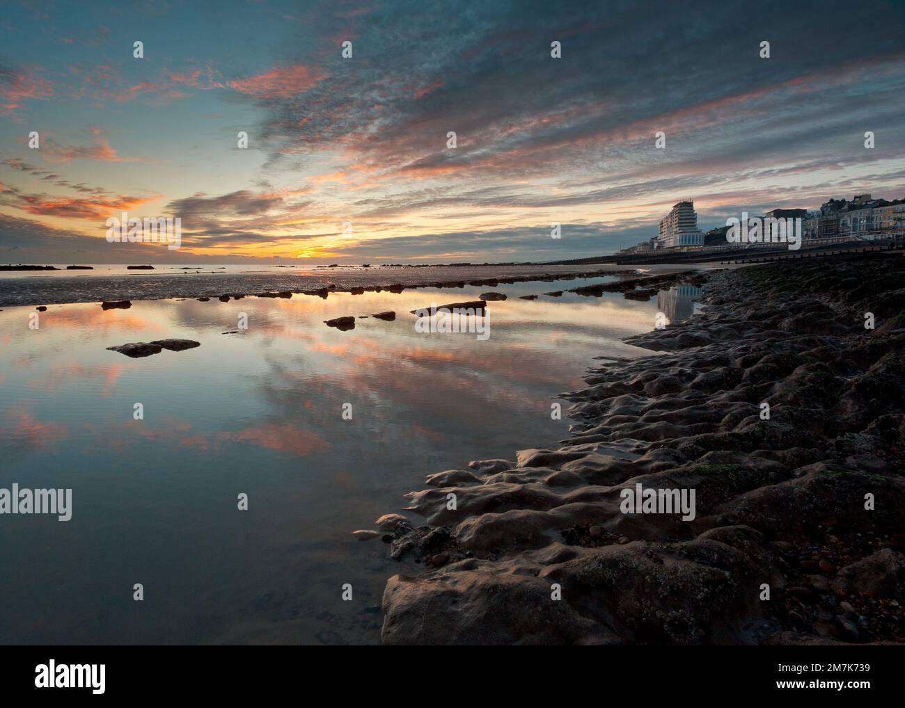 Sunset at St Leonards On Sea beach at low tide. Marine Court in the ...