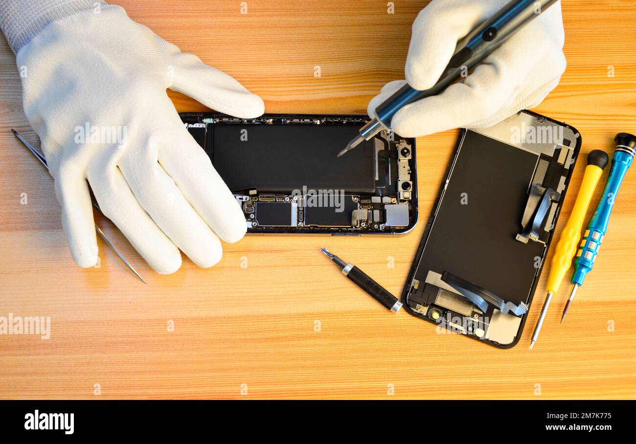 Top view of a technician repairing a smartphone Stock Photo - Alamy