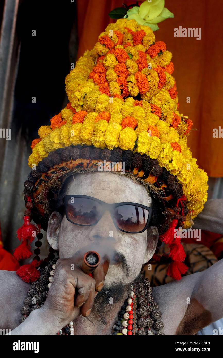 Naga Sadhu smokes marijuana with his followers at a transit camp on the ...
