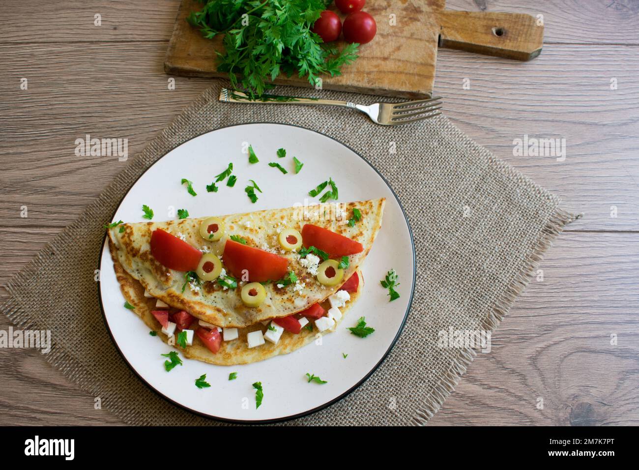 Cheese crepe, homemade cheese tomato crepe presentation Stock Photo - Alamy