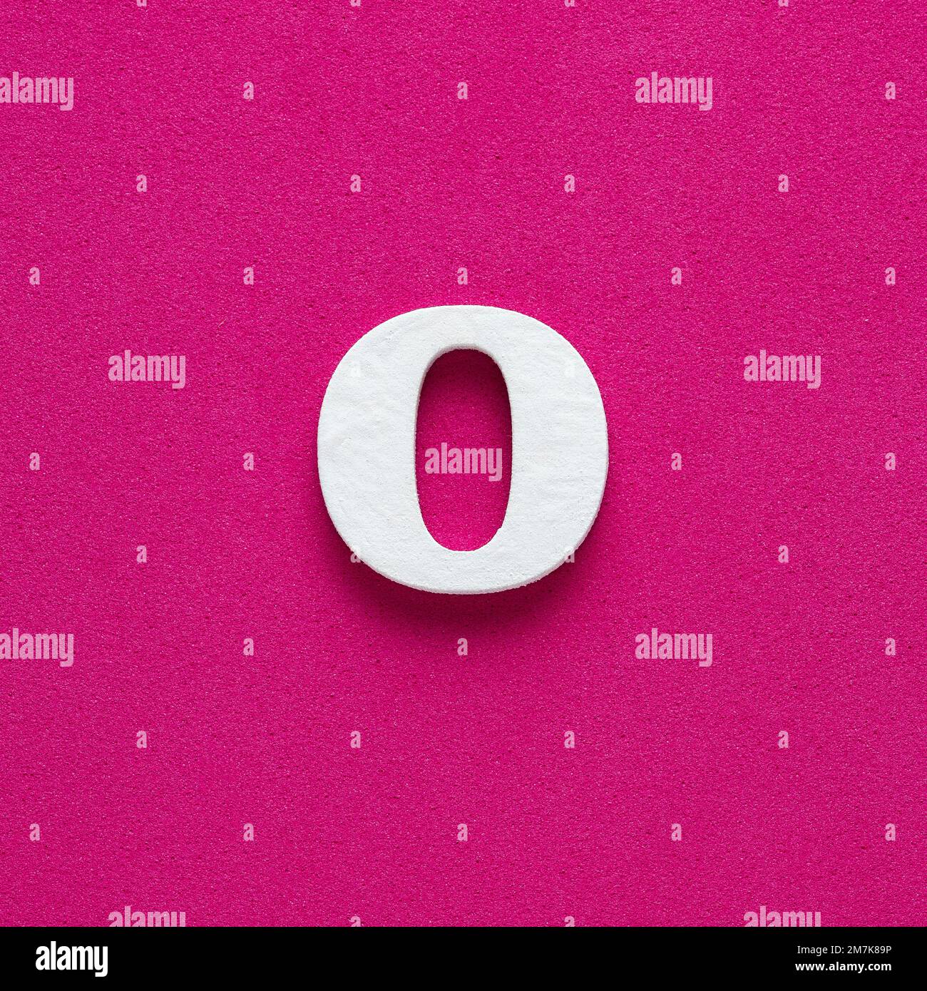 Alphabet letter O - White wooden letter on rhodamine red background ...
