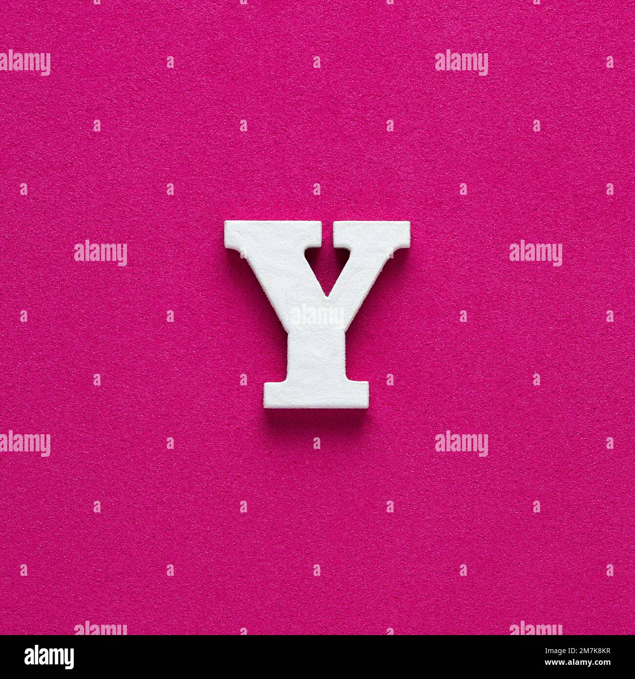 Alphabet letter Y - White wooden letter on rhodamine red background ...