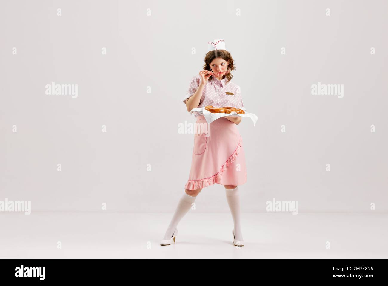 Beautiful young girl in image of retro cater waiter wearing 70s, 80s ...