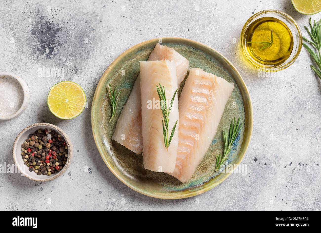 Ceramic plate with fresh cod fish, rosemary, lime, salt Stock Photo - Alamy