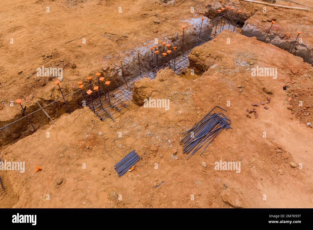 Installing steel in trench for house foundation on construction site as ...