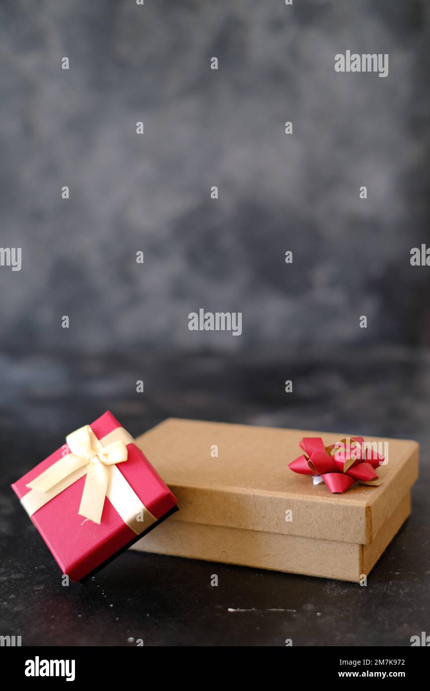 Brown and red gift boxes on dark background Stock Photo - Alamy