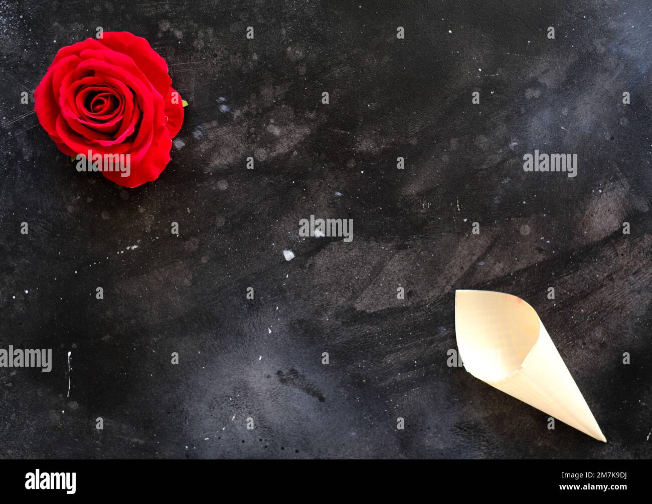 Top view of a red rose and a cone on dark background Stock Photo - Alamy