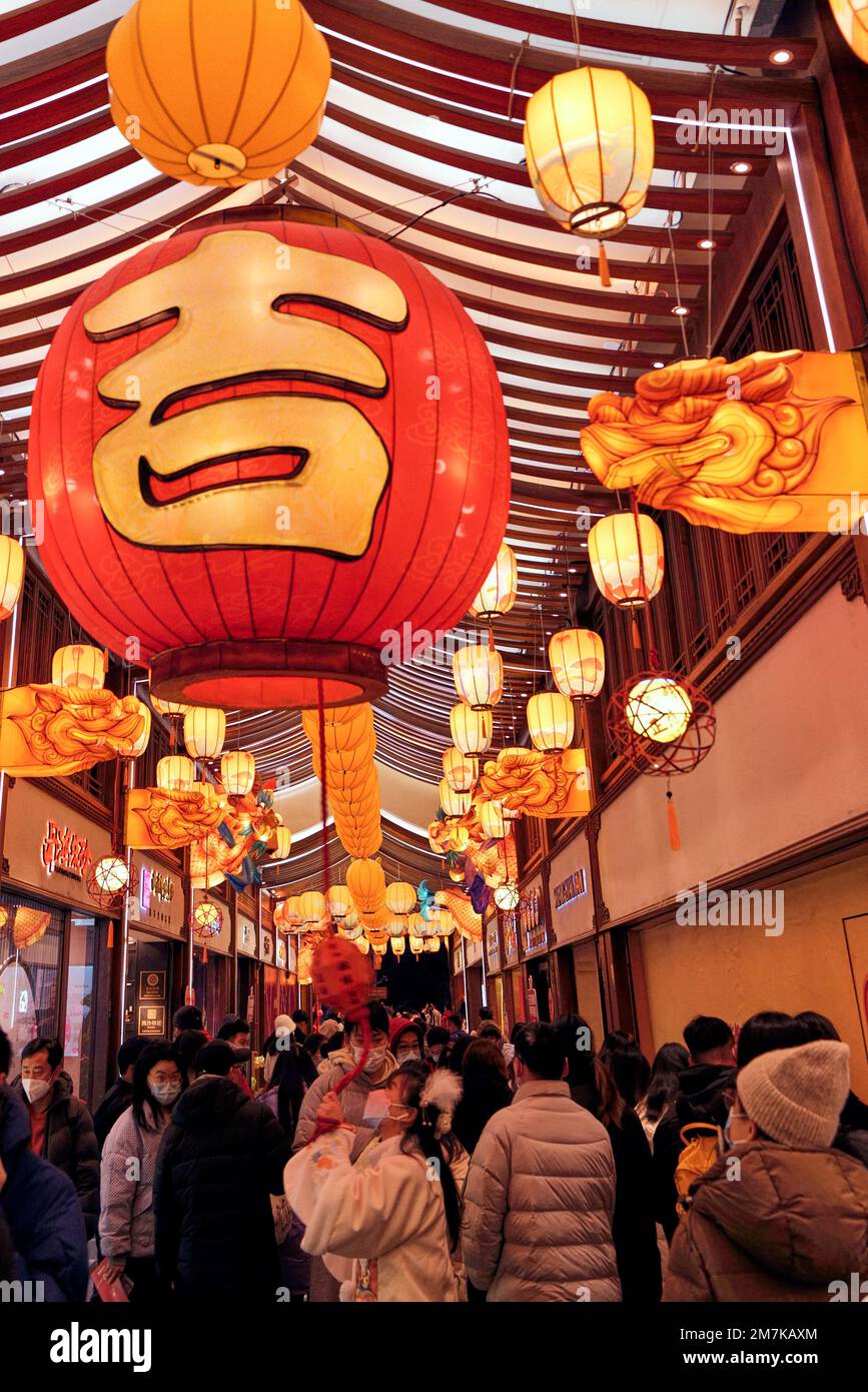 Chinese new year celebration in the Yu Garden of Shanghai, a girl ...