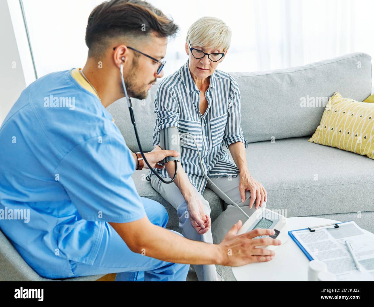 nurse doctor senior care caregiver help check exam blood pressure check ...
