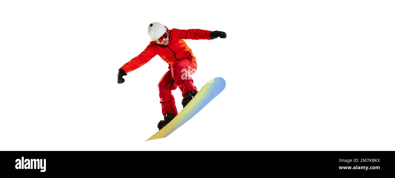 Portrait of active man, snowboarder in uniform riding on snowboard ...