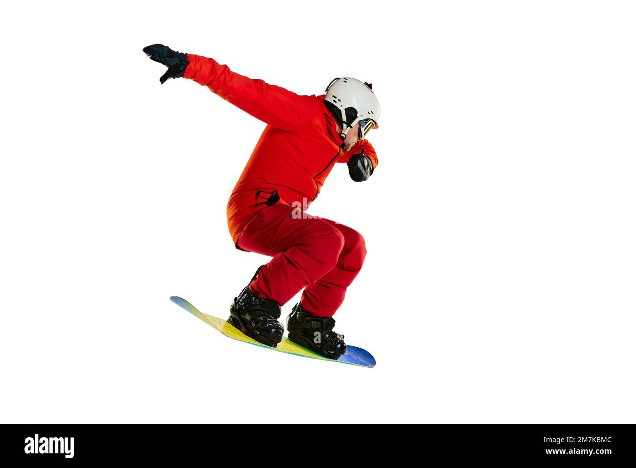 Doing tricks. Portrait of active man, snowboarder in uniform riding on ...