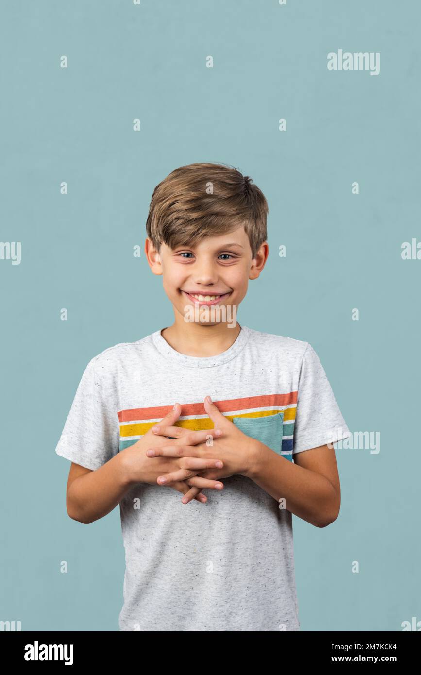 a cute autistic elementary school boy on a mint green background with ...