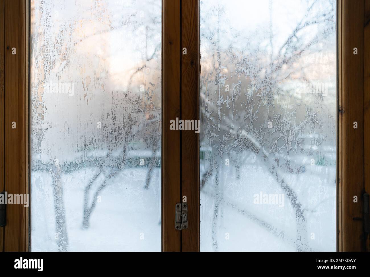 window with traces of frost on the glass. frosted glass. frost pattern ...
