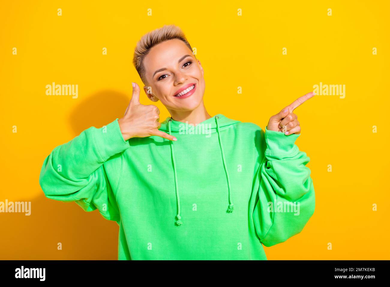 Photo of charming pretty girl toothy smile hand demonstrate call me ...