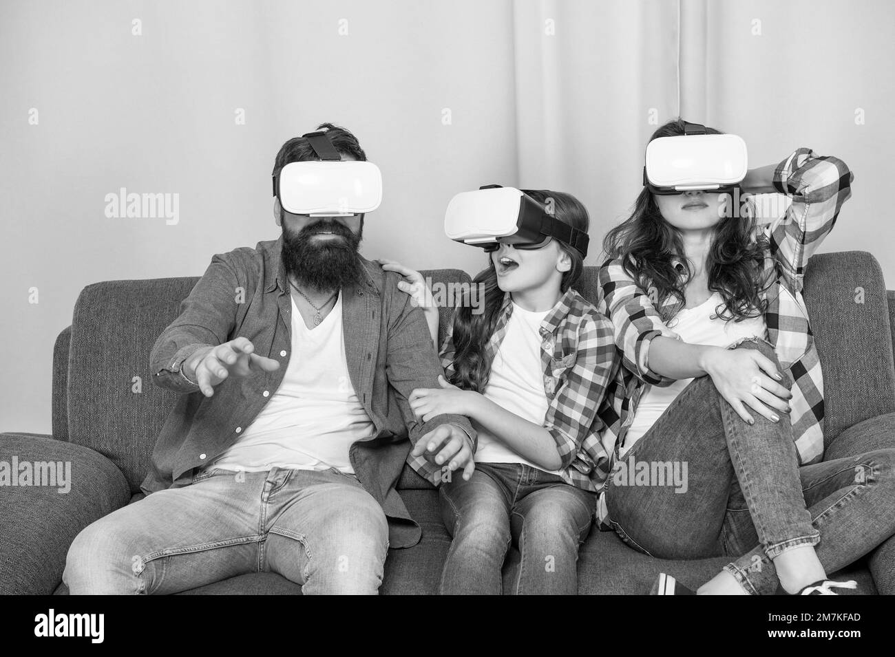 modern life. father mother and child VR glasses. virtual reality family ...