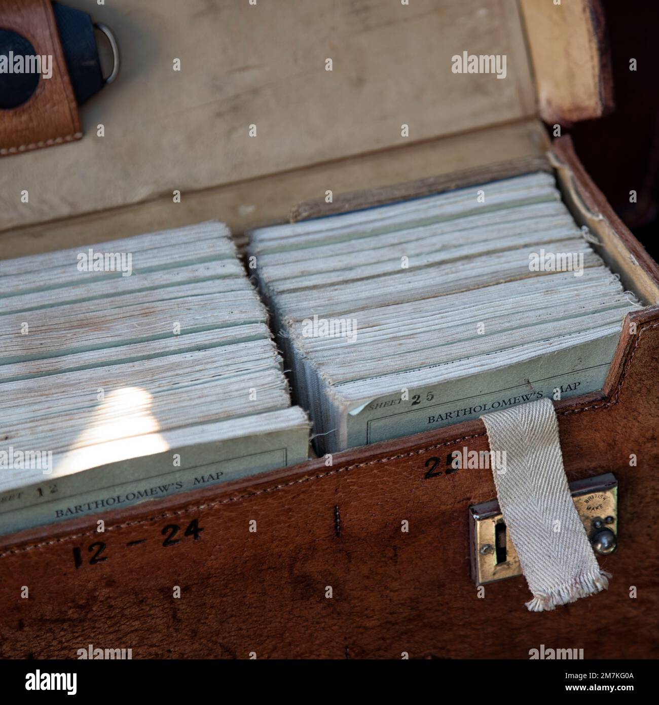 SUSSEX, UK - SEPTEMBER 14, 2019: Old maps stored in a leather map case ...