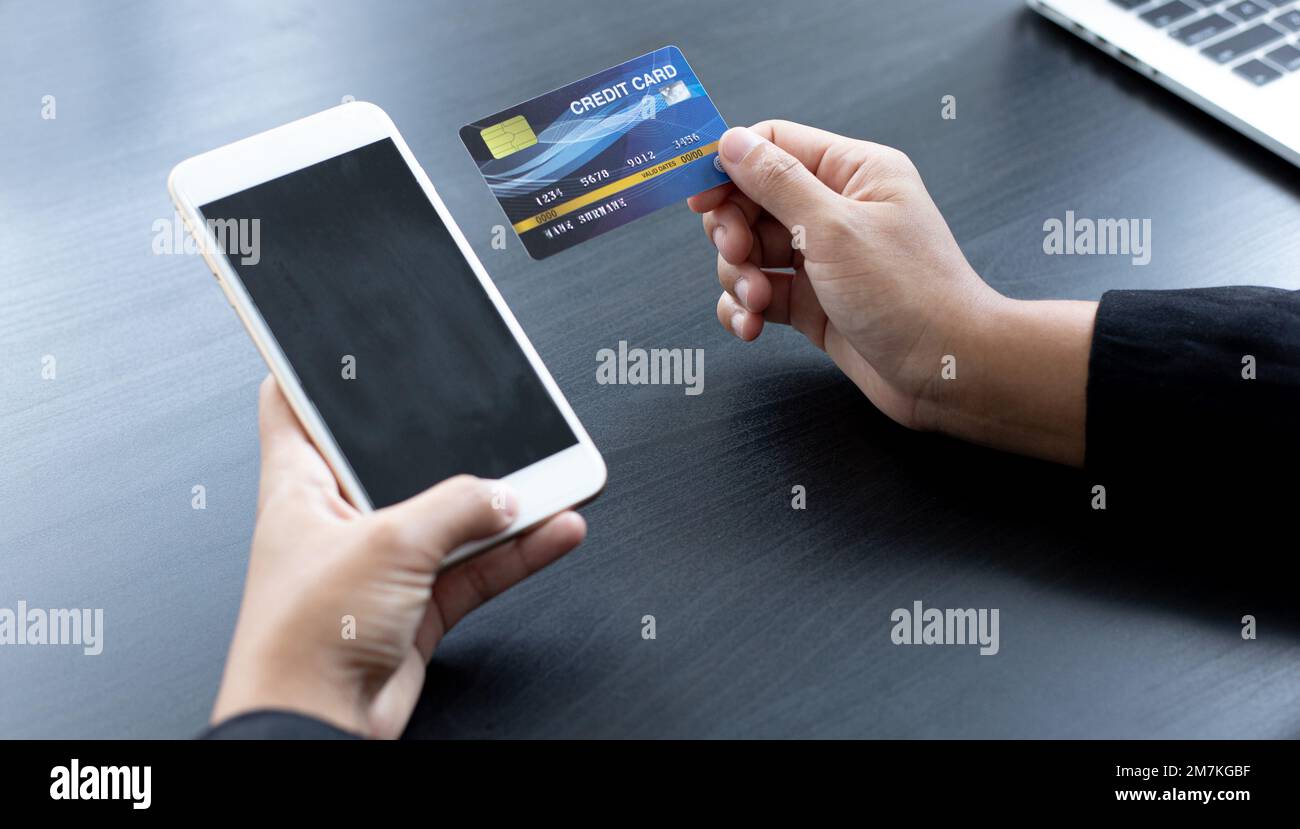 women use smart phone to register online purchases using credit card ...