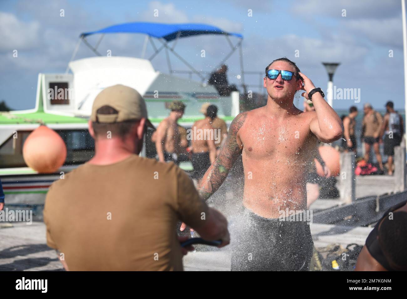 U.S. Navy Second Class Diver Jake Buyeske gets a freshwater wash down ...