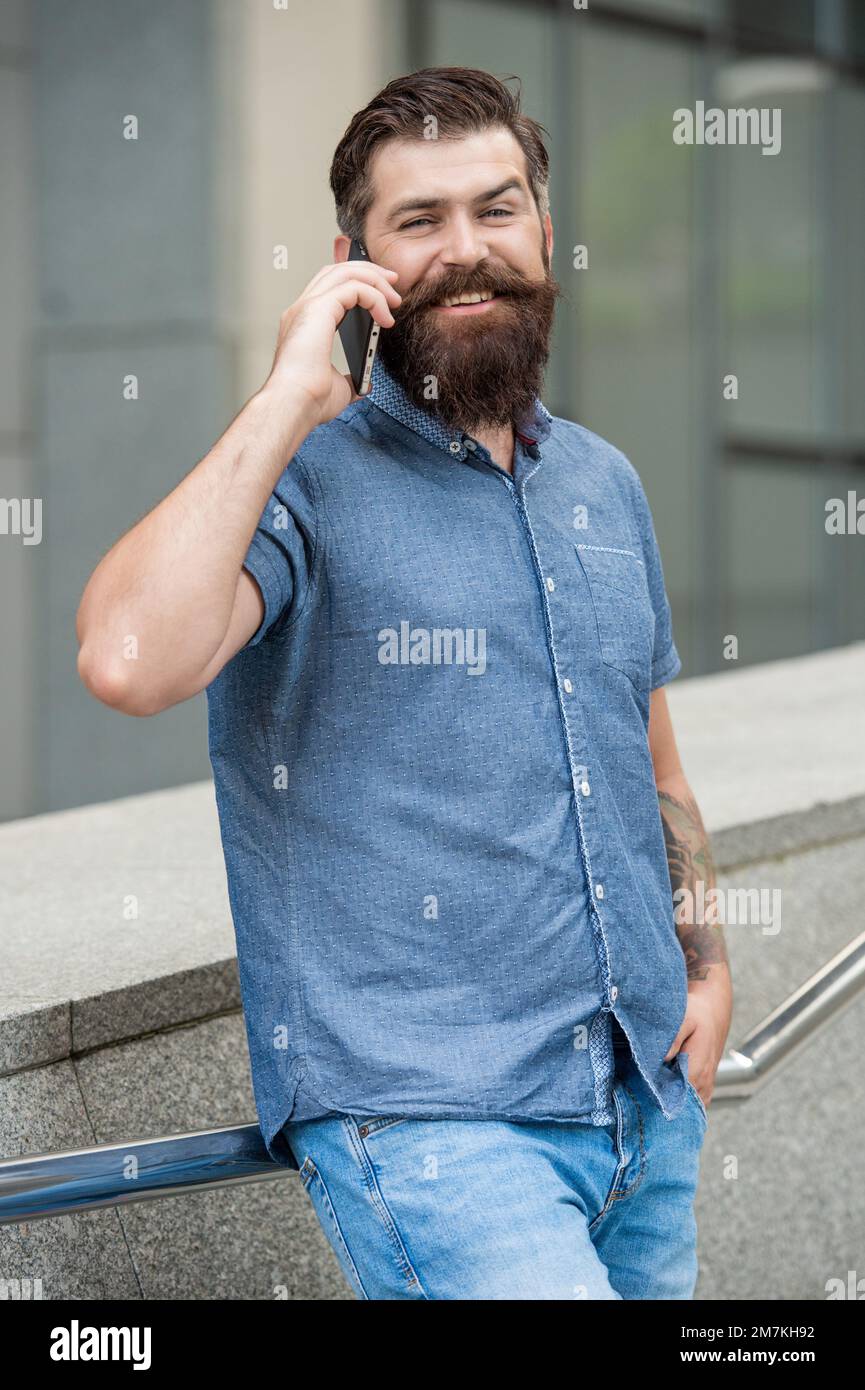 glad man speak on smartphone outdoor. man speak on smartphone outside ...