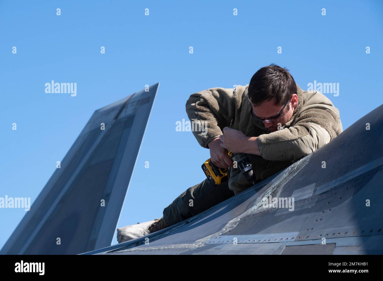 A crew chief with the 192nd Fighter Wing, works on an F-22 Raptor May ...