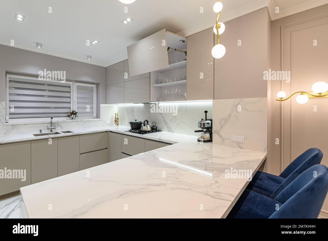 Luxury white modern marble kitchen in studio space Stock Photo - Alamy