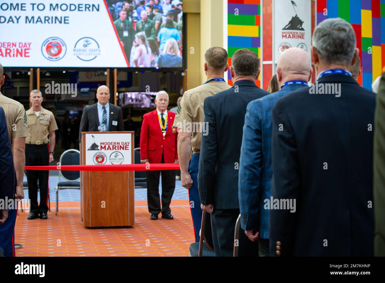 U.S. Marines and attendees of the ribbon cutting ceremony stand at ...