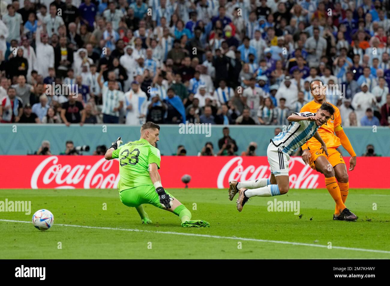 Argentina's Nahuel Molina, right, scores the opening goal past ...
