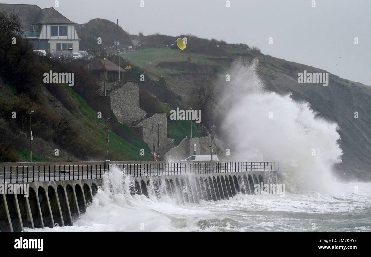 Waves crash over the promenade during rain and strong winds in ...