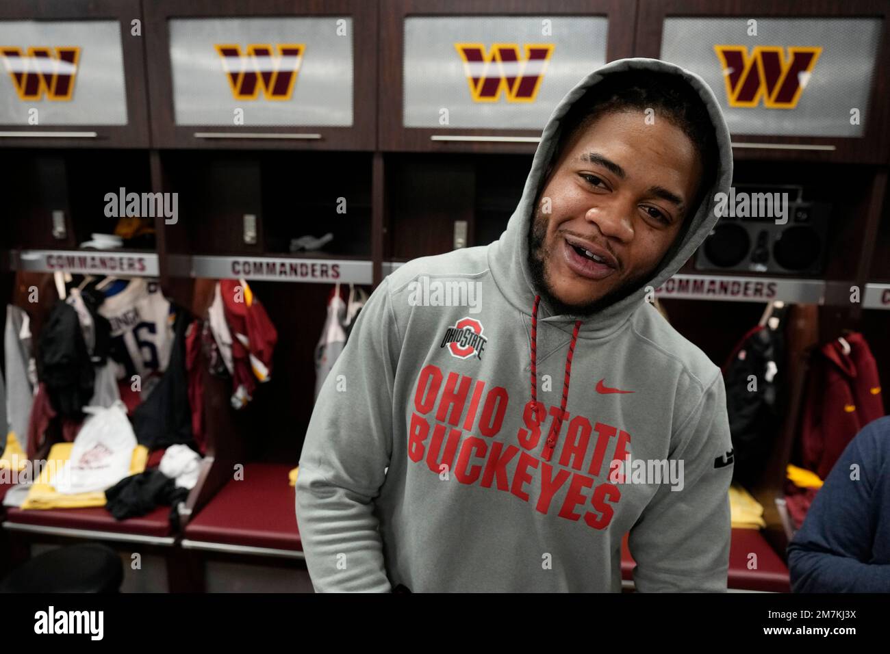 Washington Commanders' defensive end Chase Young speaks to reporters as ...