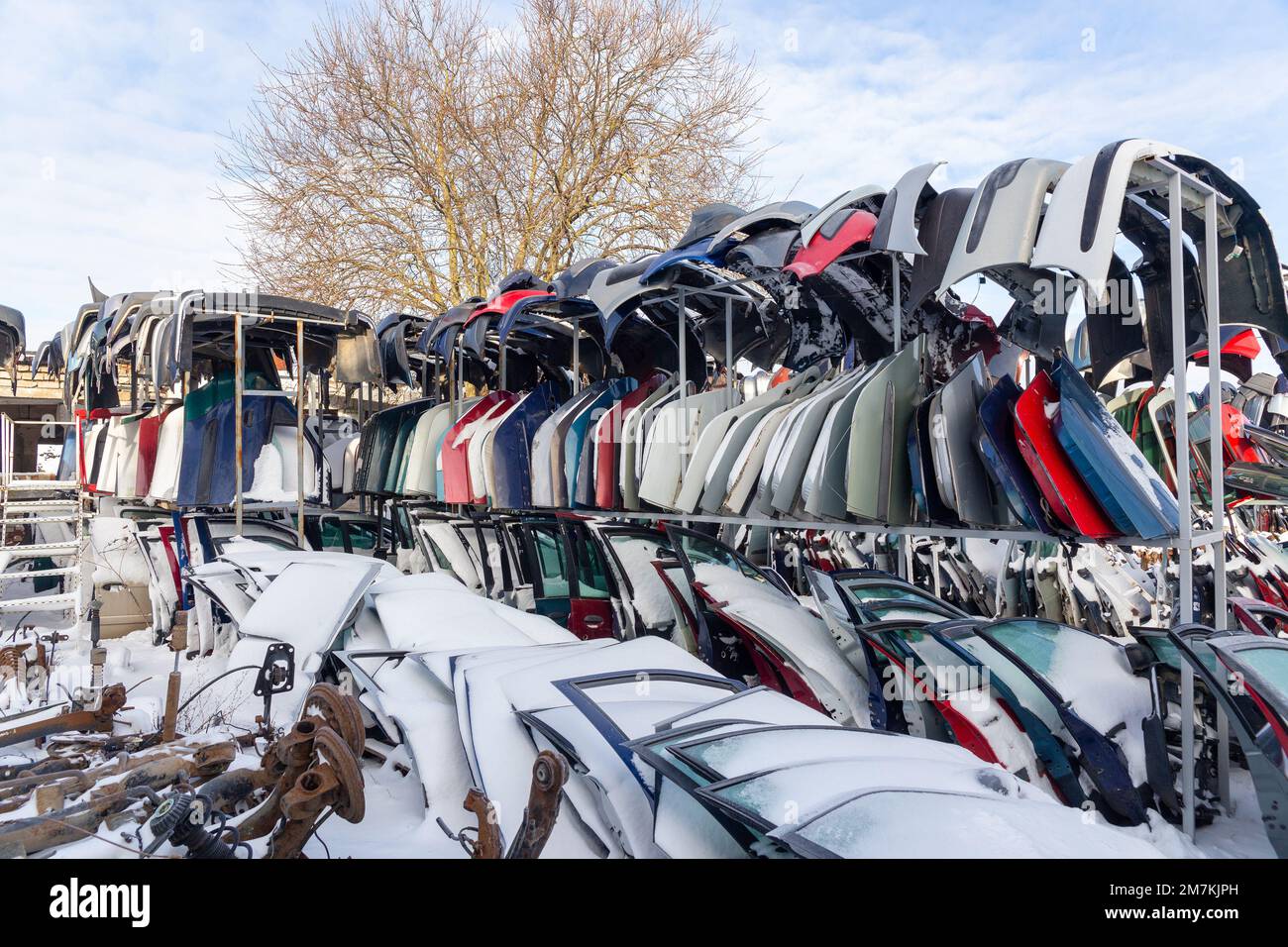 Disassembled cars on a car dump are on sale for spare parts. A stack of ...