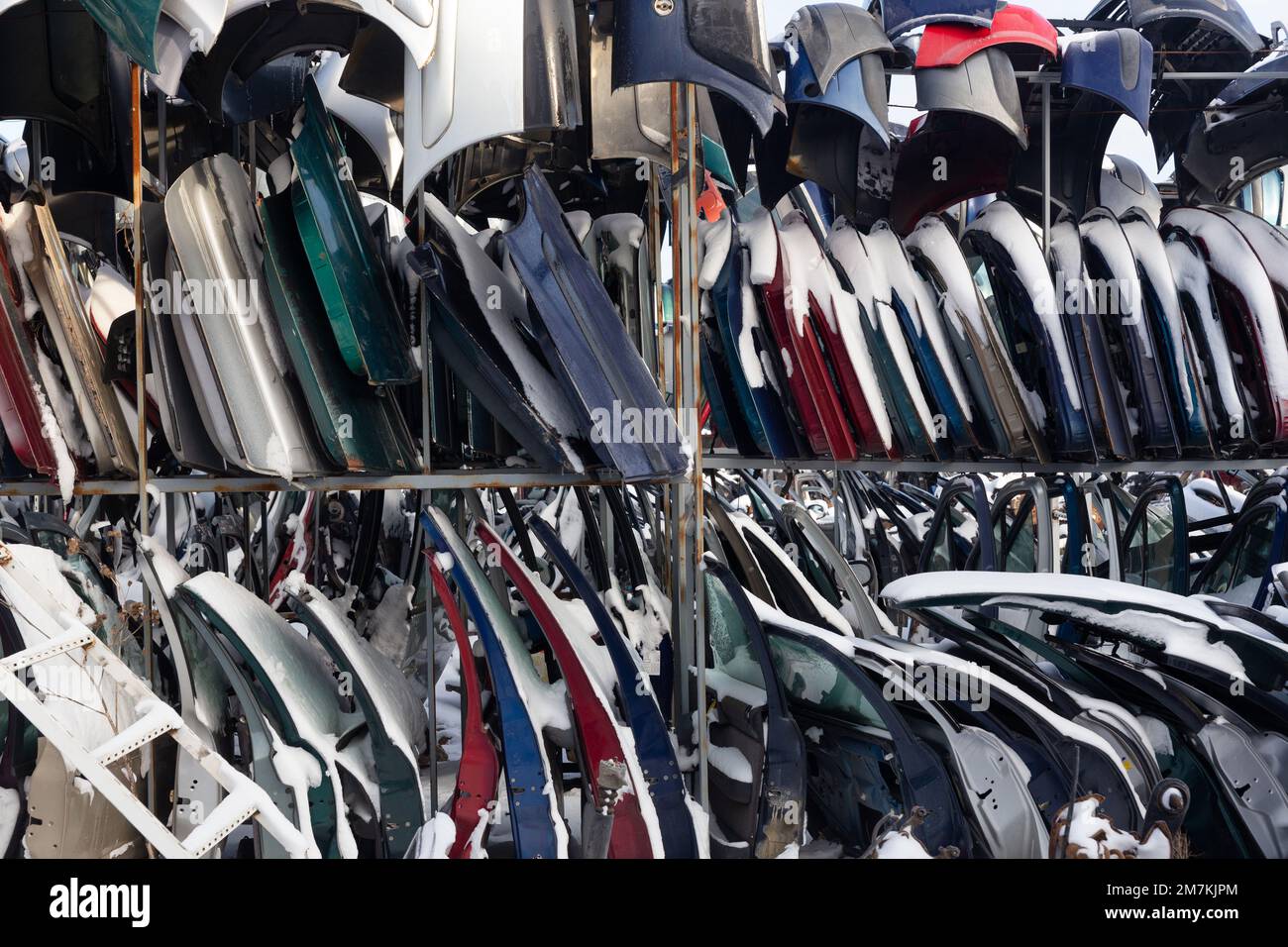 Disassembled cars on a car dump are on sale for spare parts. A stack of ...