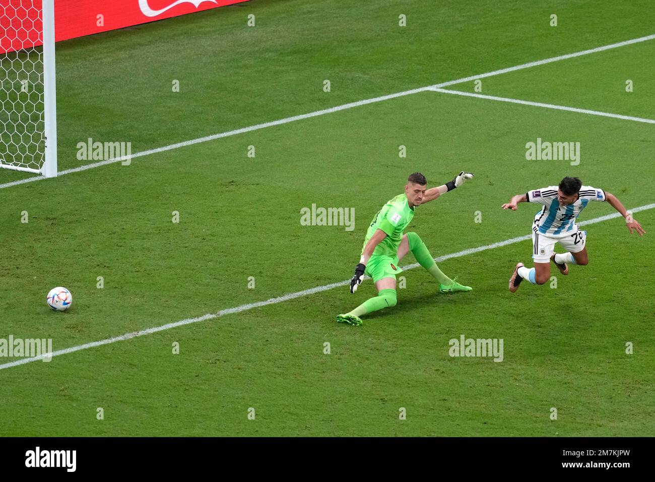 Argentina's Nahuel Molina, right, scores his side's opening goal past ...