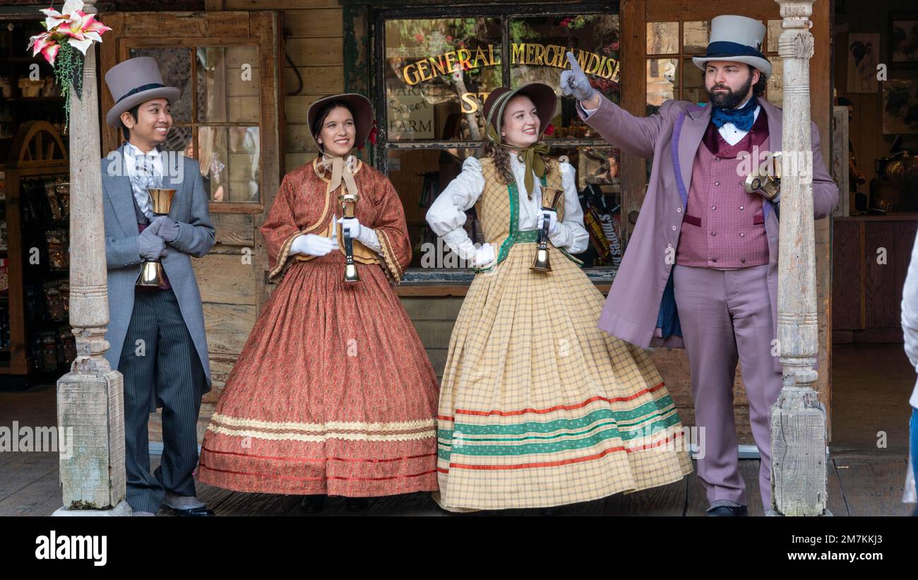 A group of people dressed up in costumes standing in front of a store ...