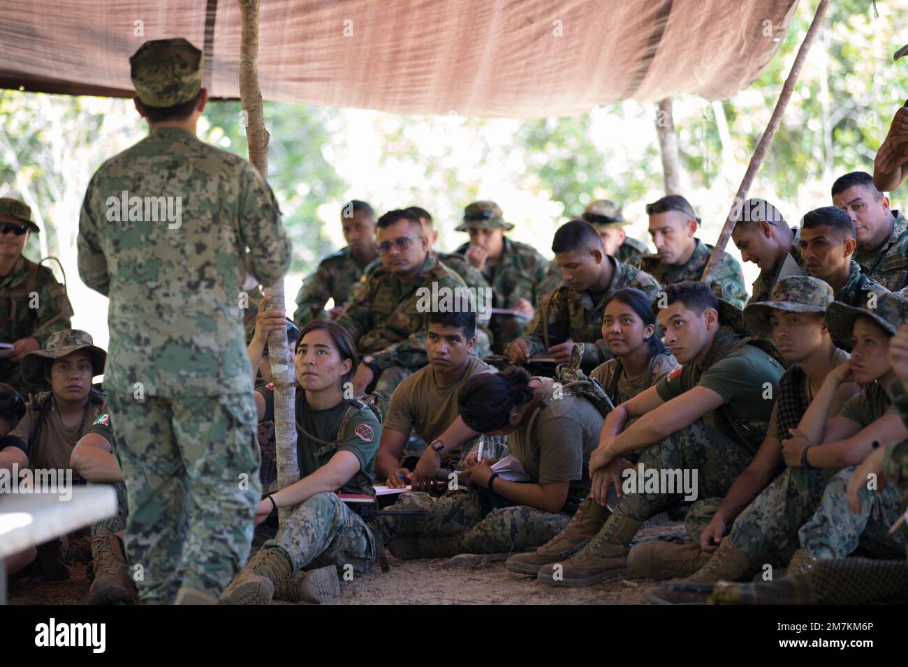 Soldiers from Mexico and Colombia listen to an instructor from the U.S ...