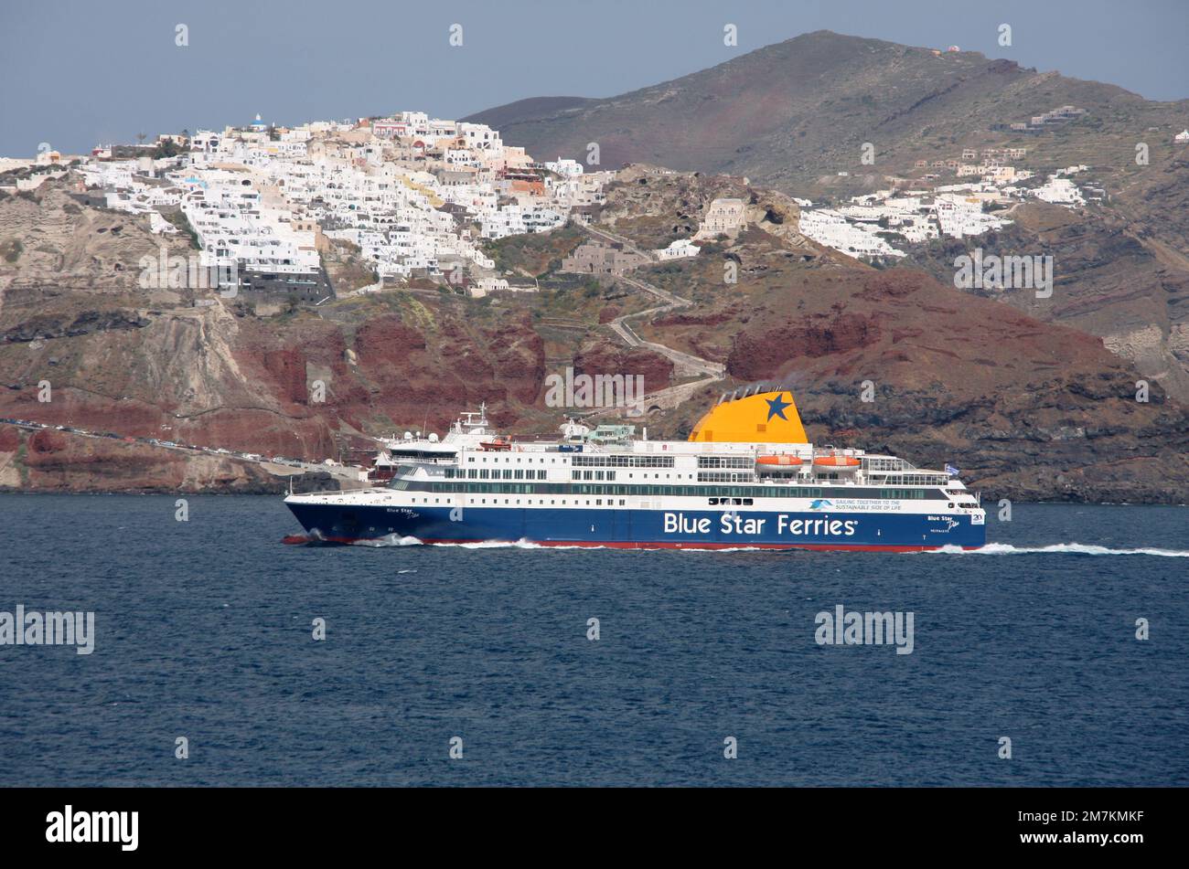 A Blue Star Ferries vessel passes below Oia Santorini Greece Stock ...