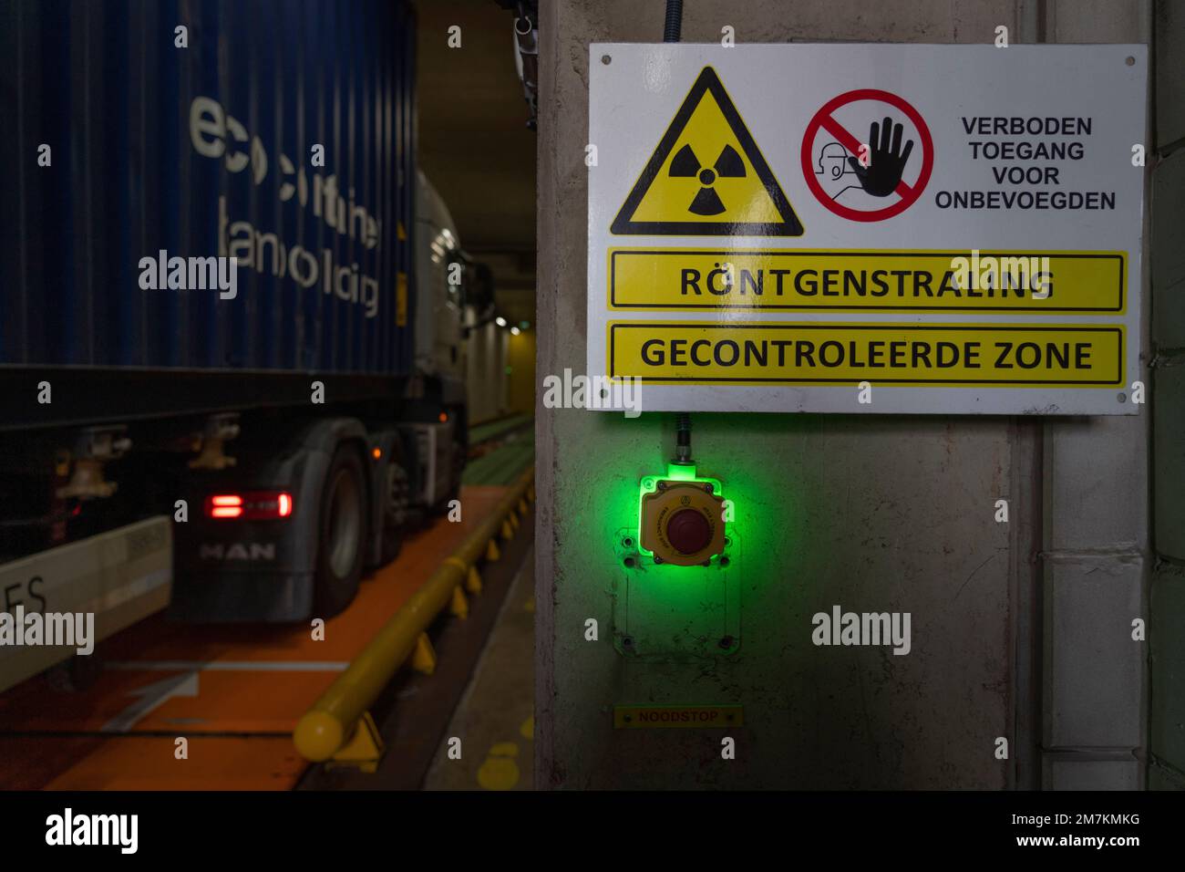 A truck carrying a shipping container enters an X-ray cargo scanning ...