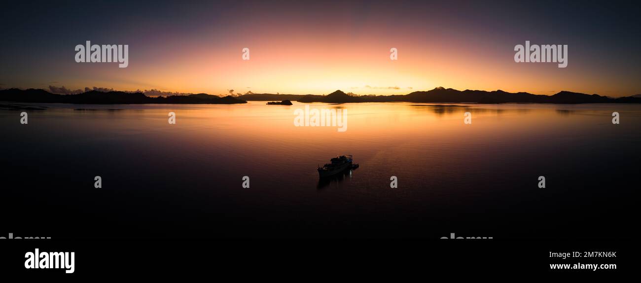 Sunrise illuminates the calm waters of the Solomon Islands. This scenic ...