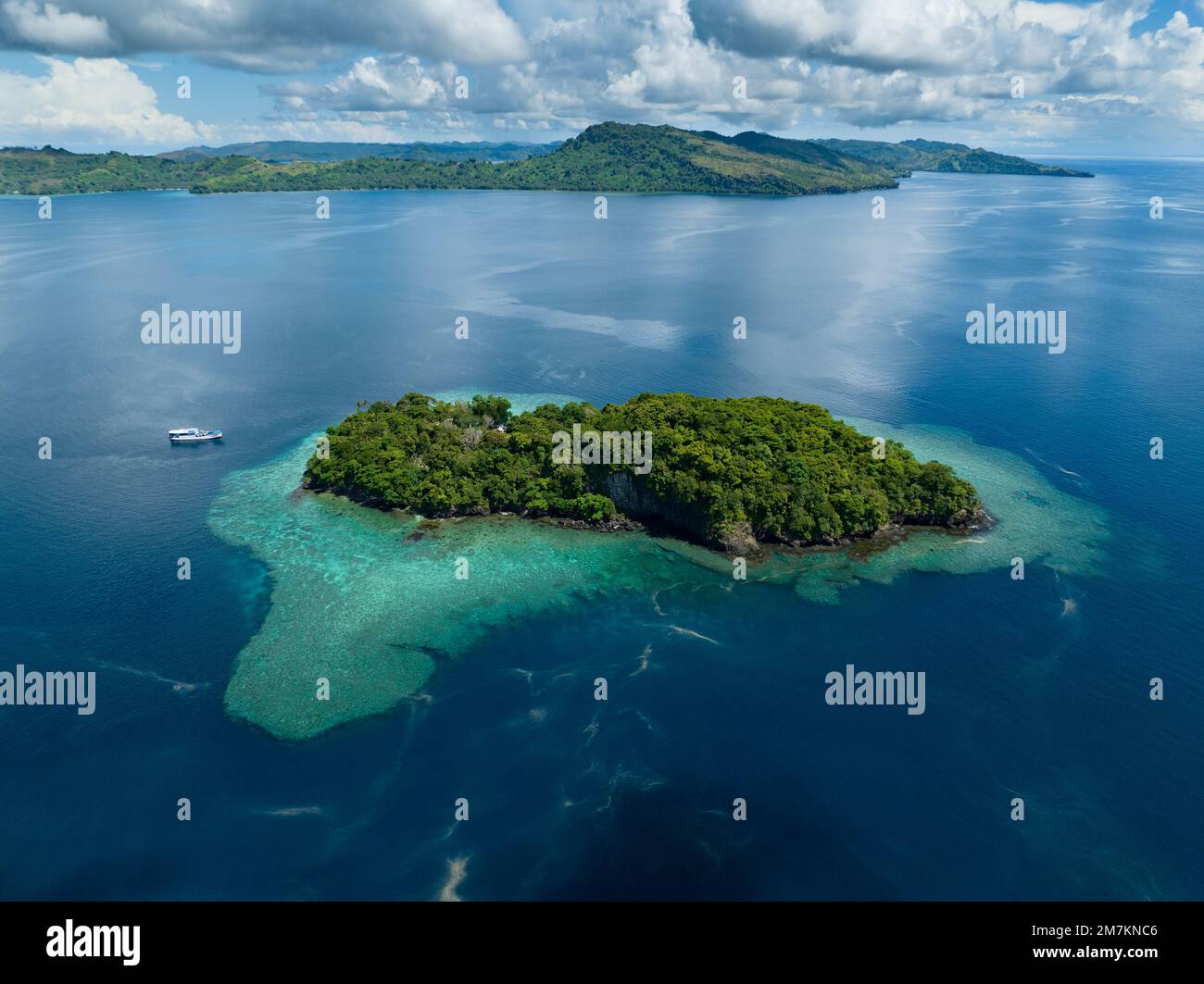 A beautiful coral reef surrounds a scenic island in the Solomon Islands ...