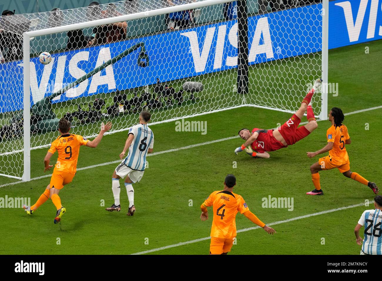 Argentina's goalkeeper Emiliano Martinez dives but fails to save the ...