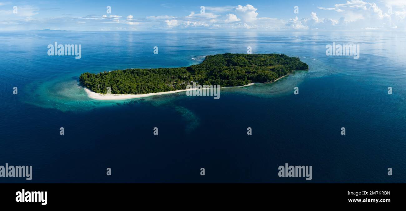 A beautiful coral reef surrounds a scenic island in the Solomon Islands ...