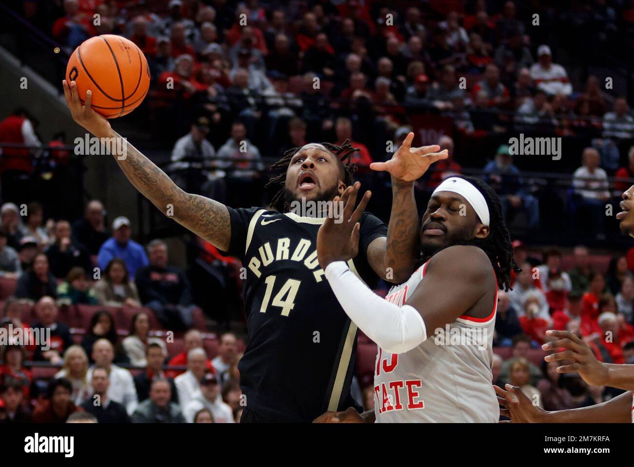 Purdue guard David Jenkins, left, shoot in front of Ohio State guard ...
