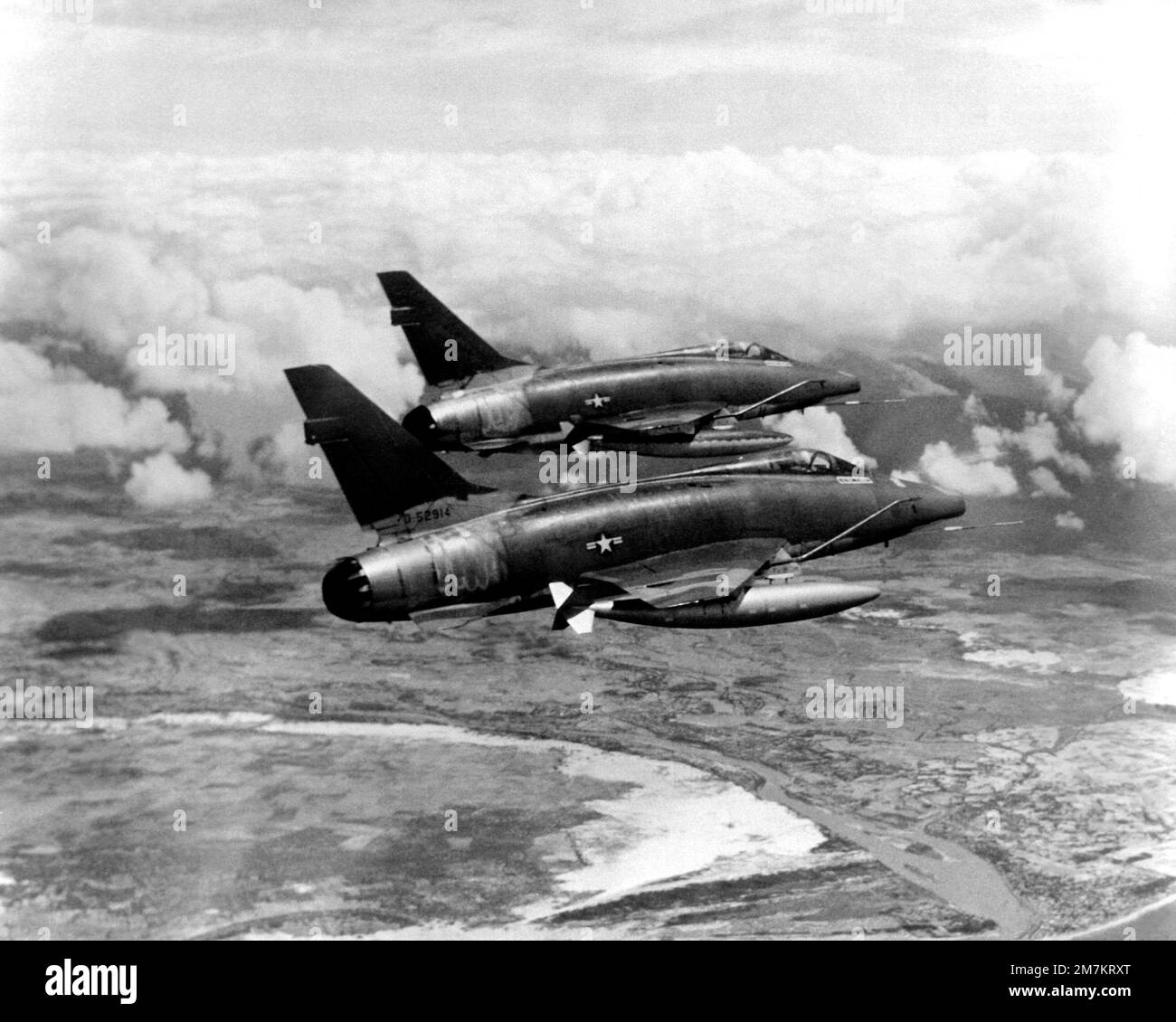 AN air-to-air right rear view of two F-100D Super Sabre aircraft ...