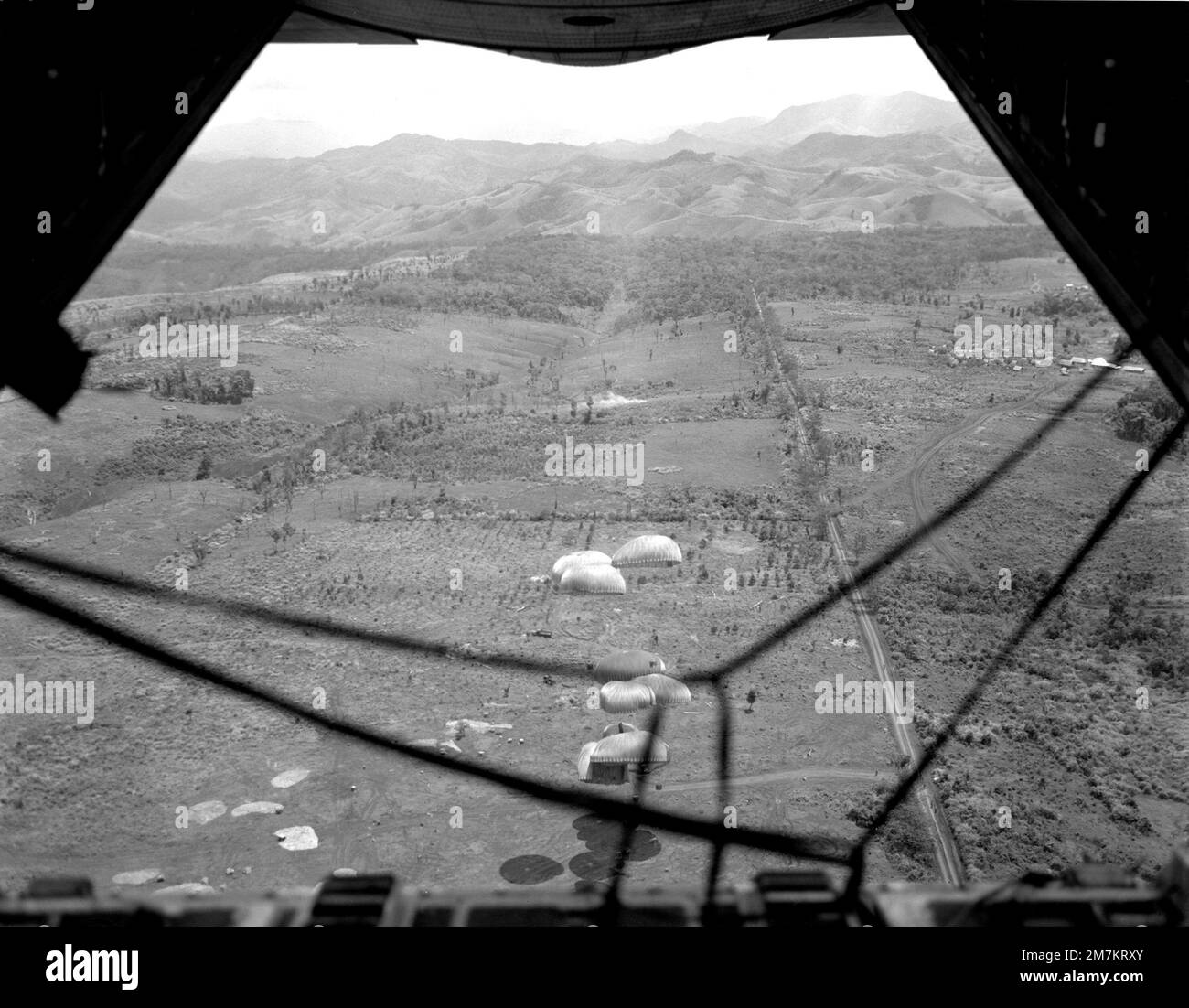 Containers of supplies are airdropped from an Air Force C-130 Hercules ...