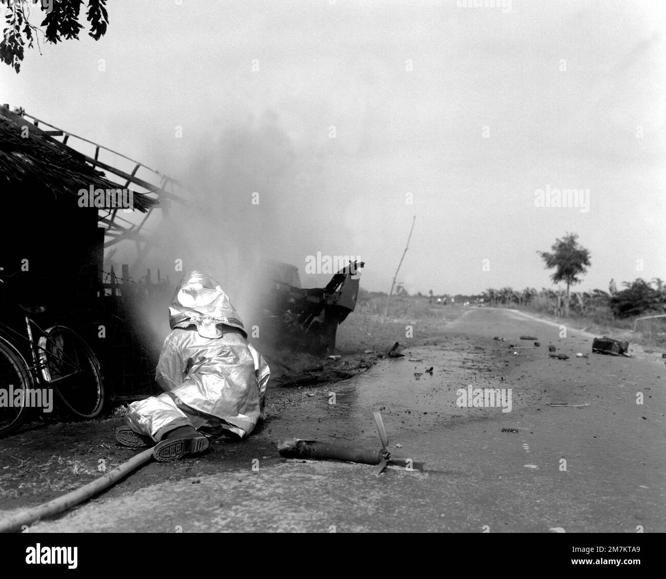 A sergeant sprays water on an explosive ordnance disposal (EOD) truck ...