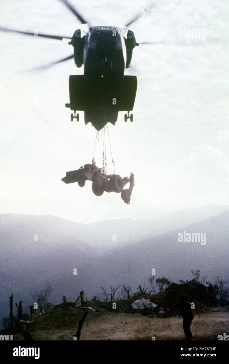 A CH-53 Sea Stallion helicopter airlifts a combination backhoe/front ...