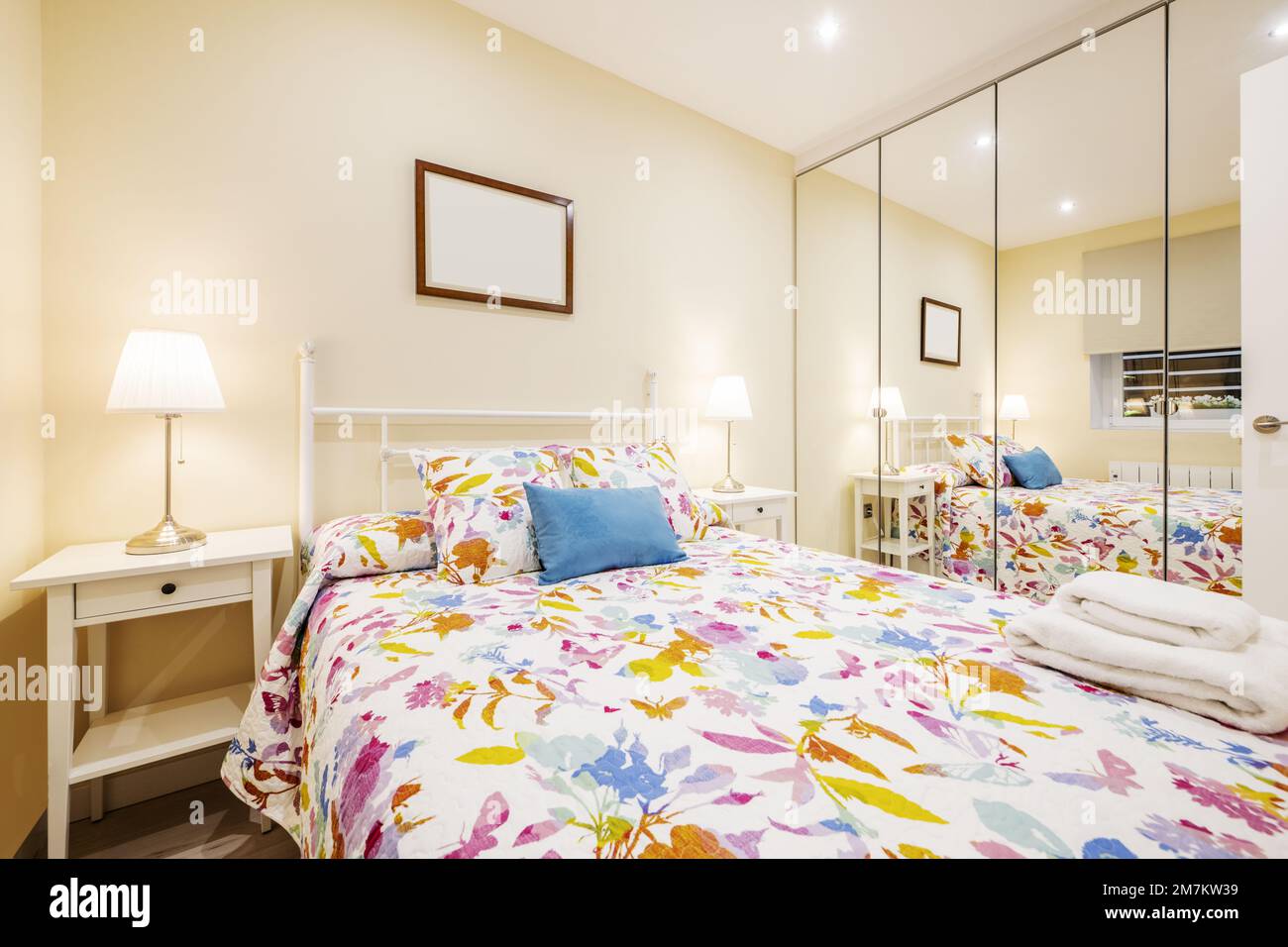 Bedroom with a double bed and a wall lined with a built-in wardrobe ...